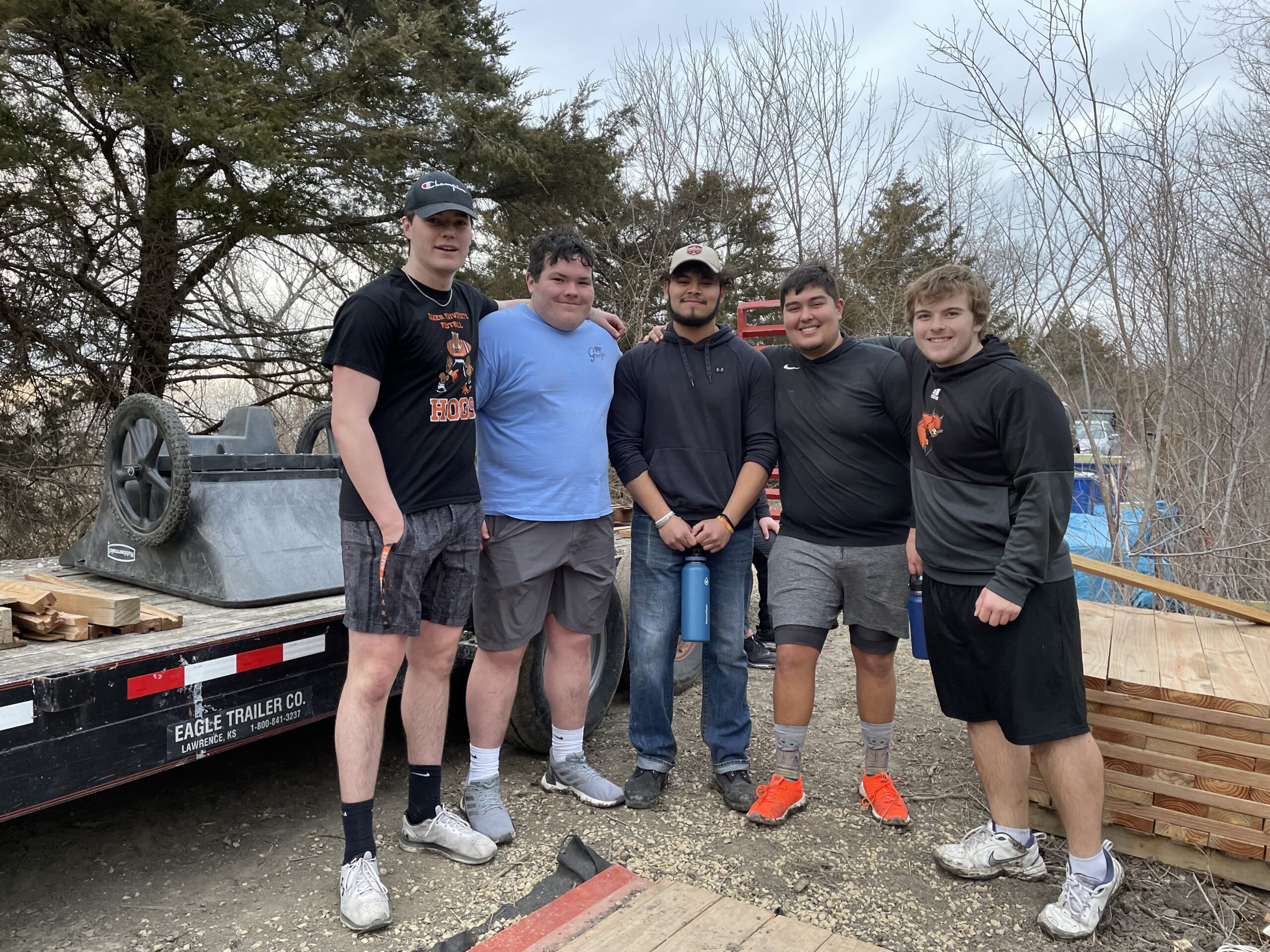 Baker football players show up to lend a hand to volunteers working on ...
